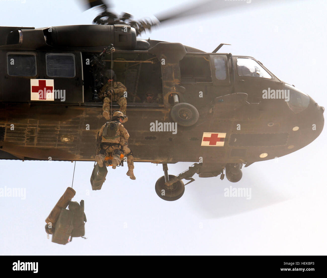 German soldiers, part of an extrication team lower to the ground with ...