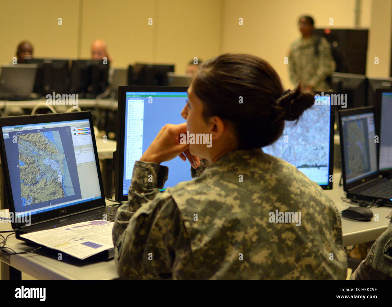 Sgt. Alcoa, operations NCO of the 372nd MP Batallion, HHD, works on 2D ...