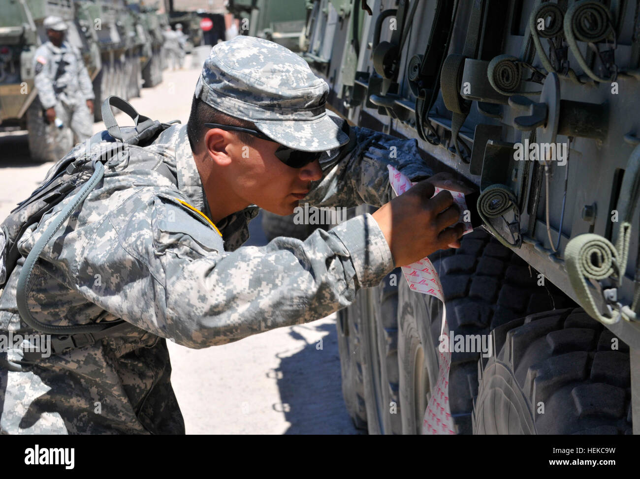A U.S. Army SAW gunner prepares a Stryker armored vehicle for ...