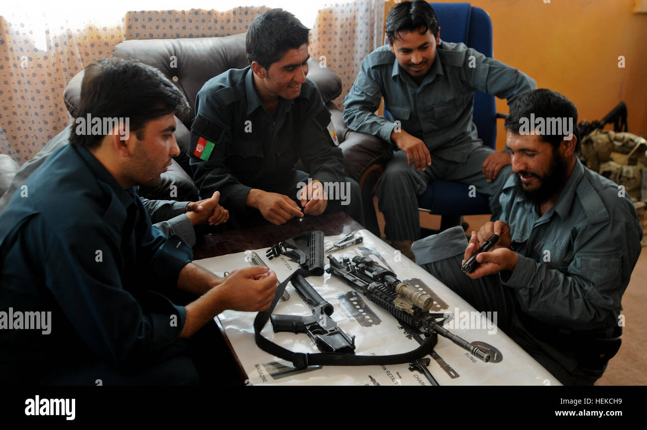 Afghan Border Policemen break down and reassemble an M4 carbine piece ...
