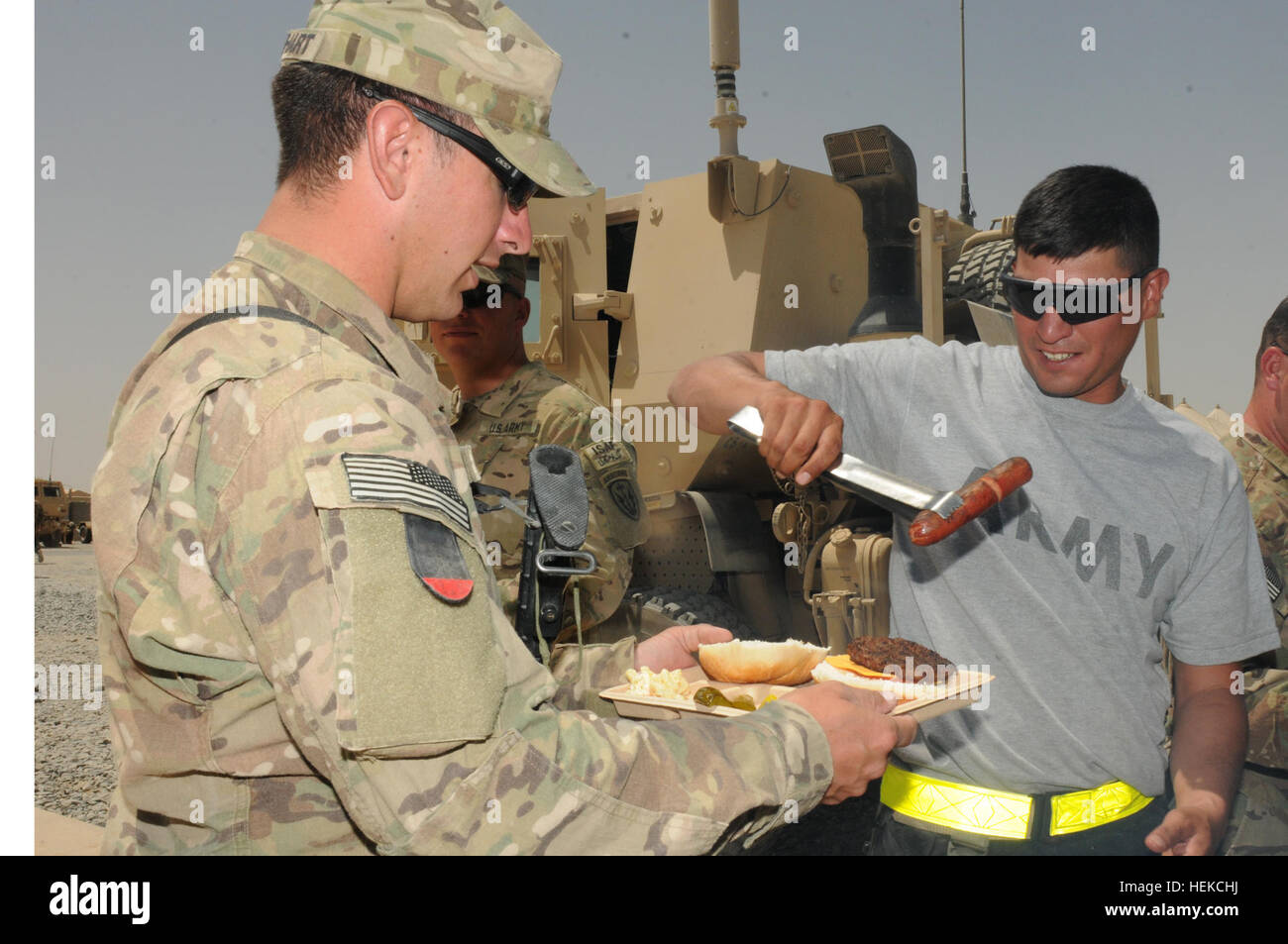 Staff Sgt. Joe Cantu, of Houston, serves a soldier in his platoon a ...
