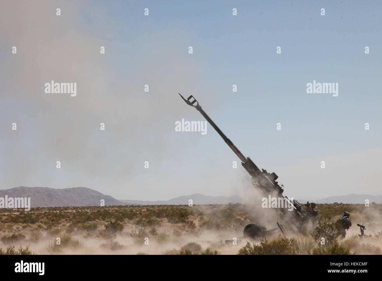 Dust spreads in the Mojave Desert after a M-777 A2 Weapon System is ...