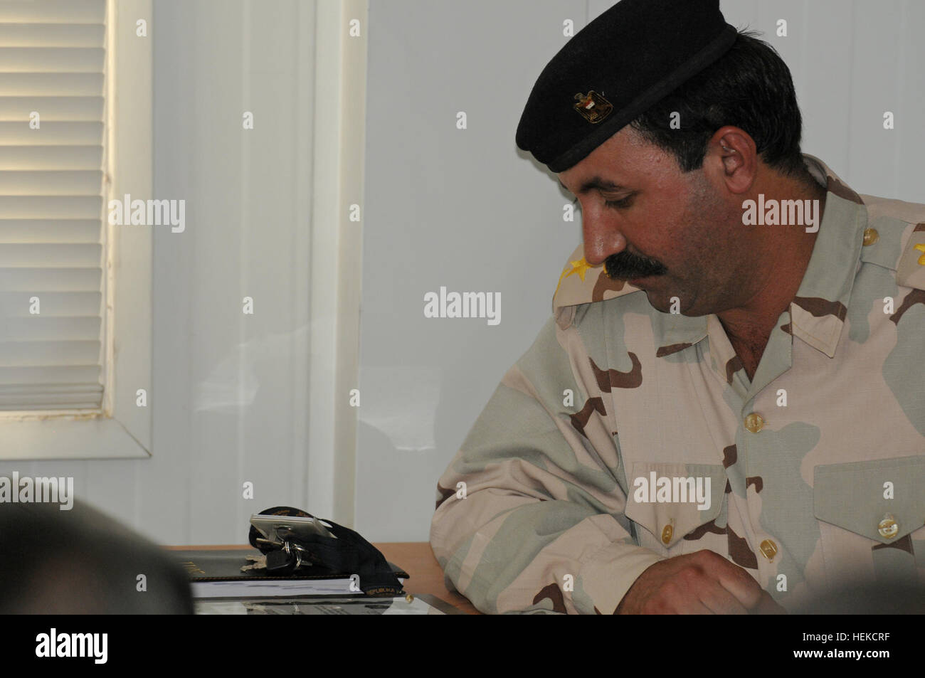 An Iraqi army officer looks at his certificate of appreciation he ...