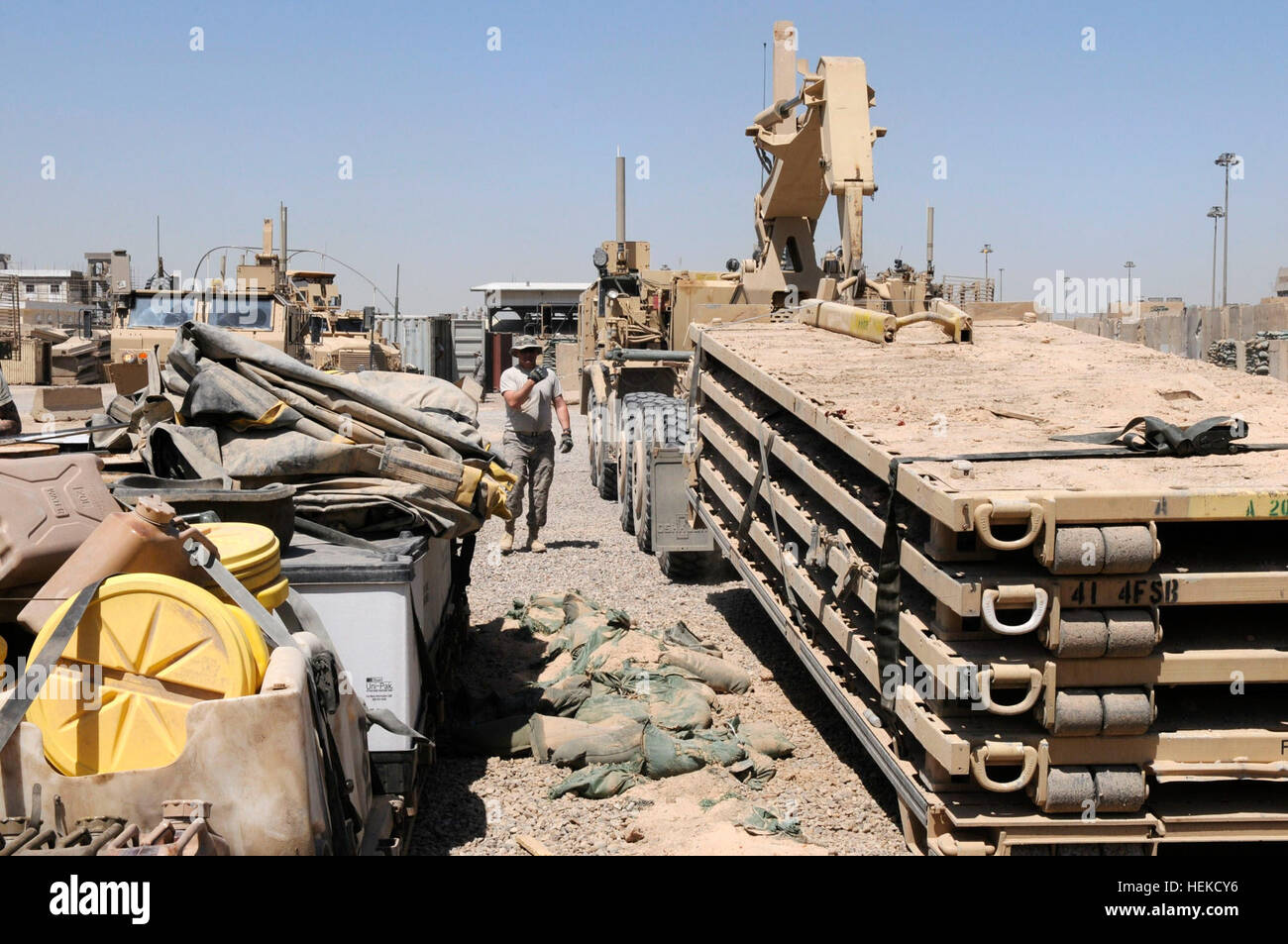 U.S. Army truck commander directs movement of flat-racks and oversees ...