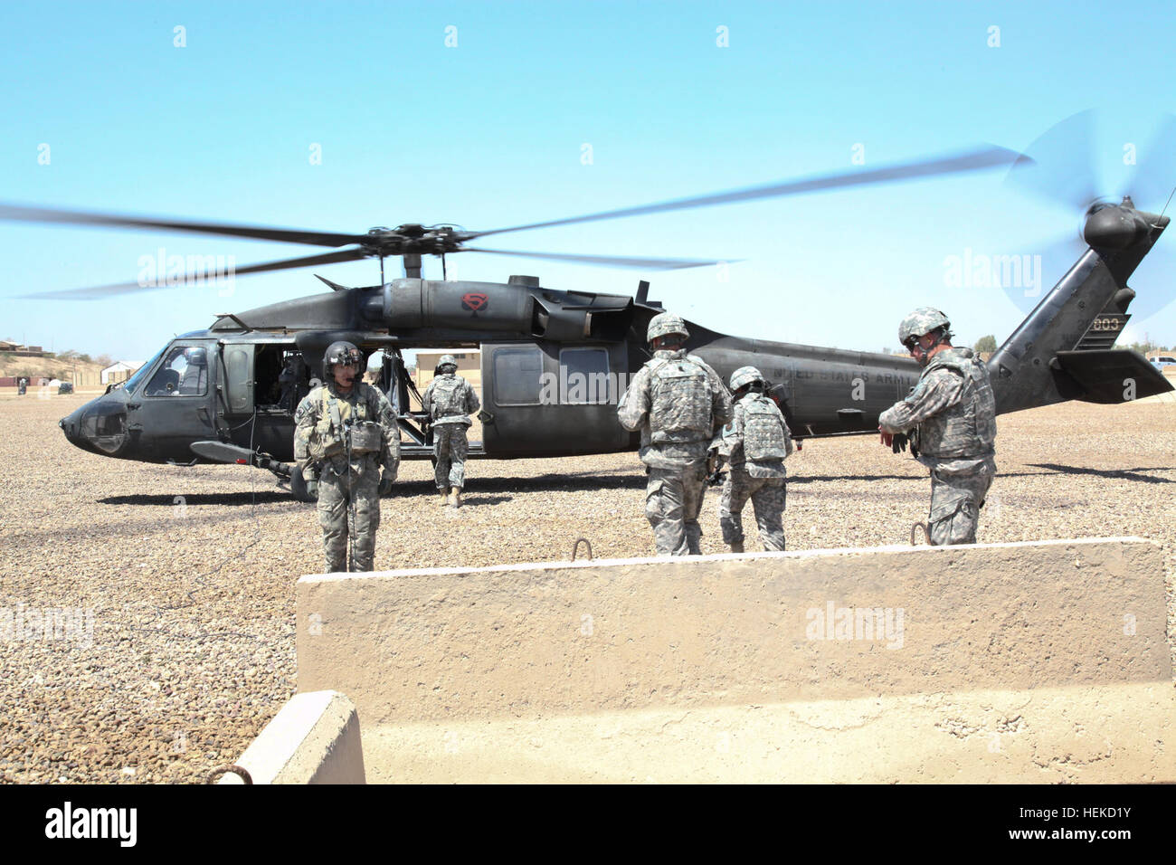 A U.S. Army soldier monitors boarding at Camp Liberty, Baghdad, Iraq ...