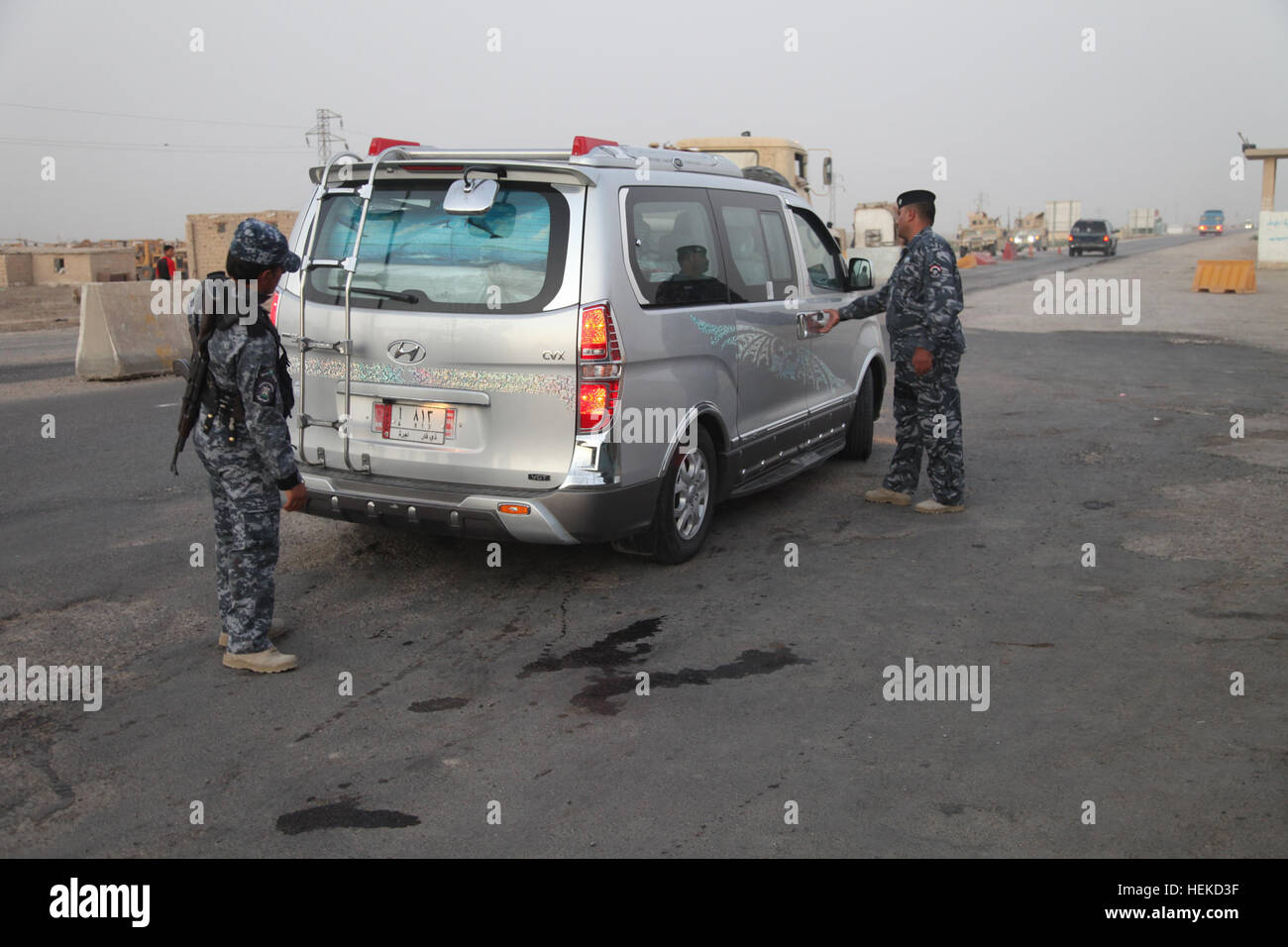 Iraqi police conduct routine vehicle inspections at an Iraqi police ...