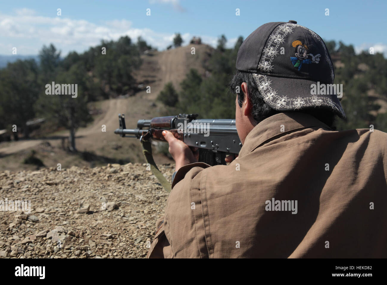 An Afghan Local Policeman monitors a valley from an observation post at ...