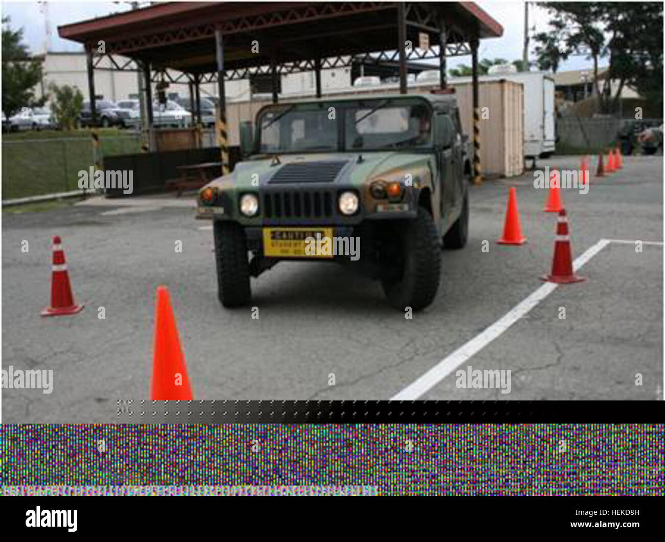 A U.S. Soldier navigates his Humvee around cones during driver training ...