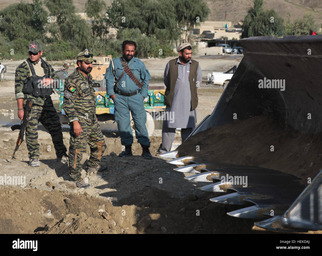 Afghan Local Police Cmdr. Aziz directs the heavy machine operation ...