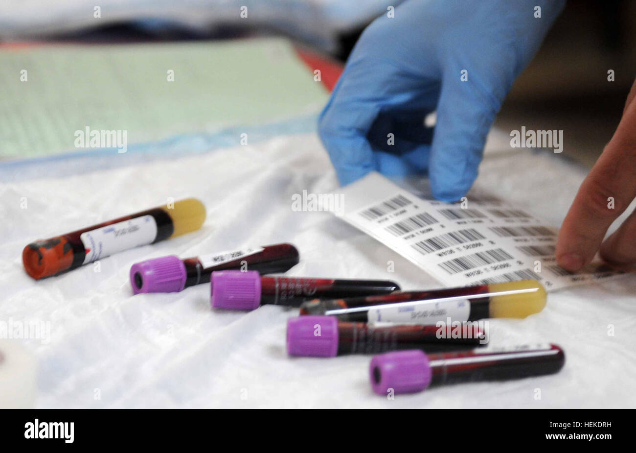 Laboratory technicians label donor blood vials during a mobile blood ...