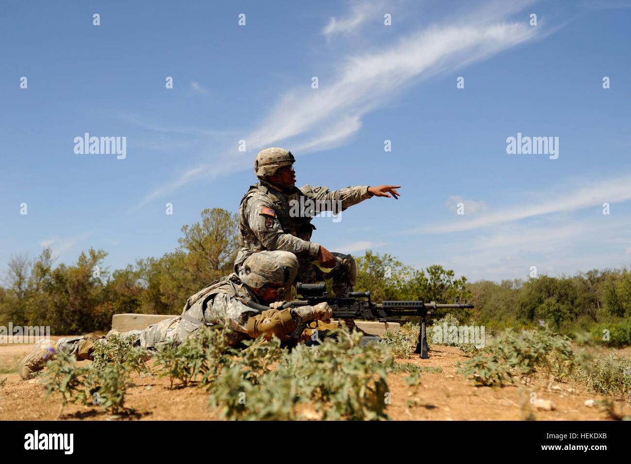 Sgt. Greg Kerr locks and loads his weapon as Spc. Archie Speights ...