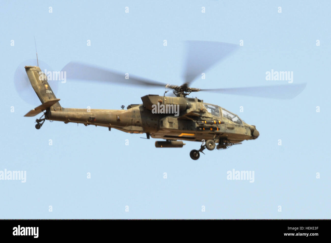 An AH-64 Apache helicopter flies over Fallujah, Iraq, during an air ...