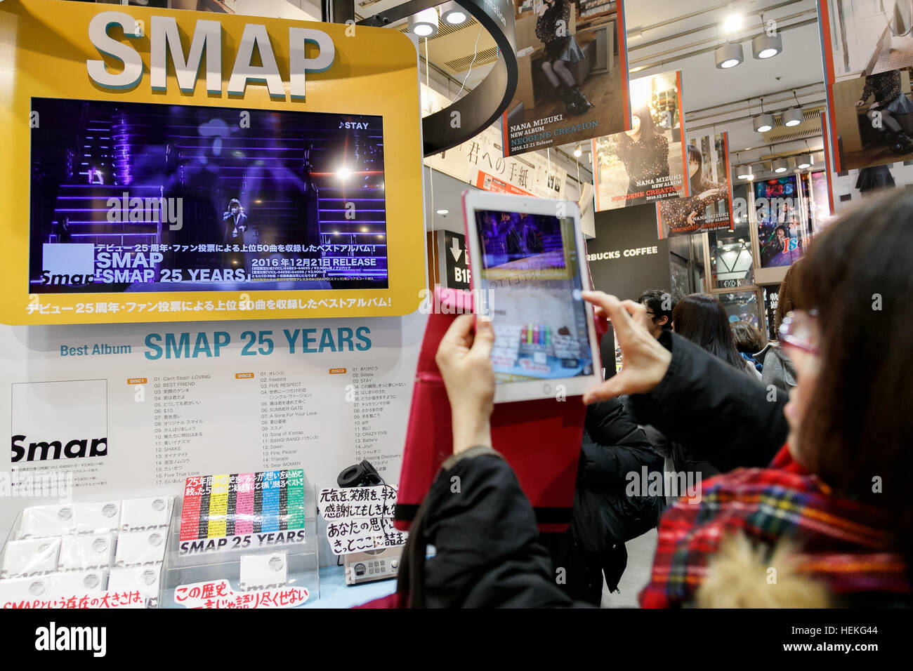 A fan takes a picture of an exhibit space for the SMAP's new album SMAP ...