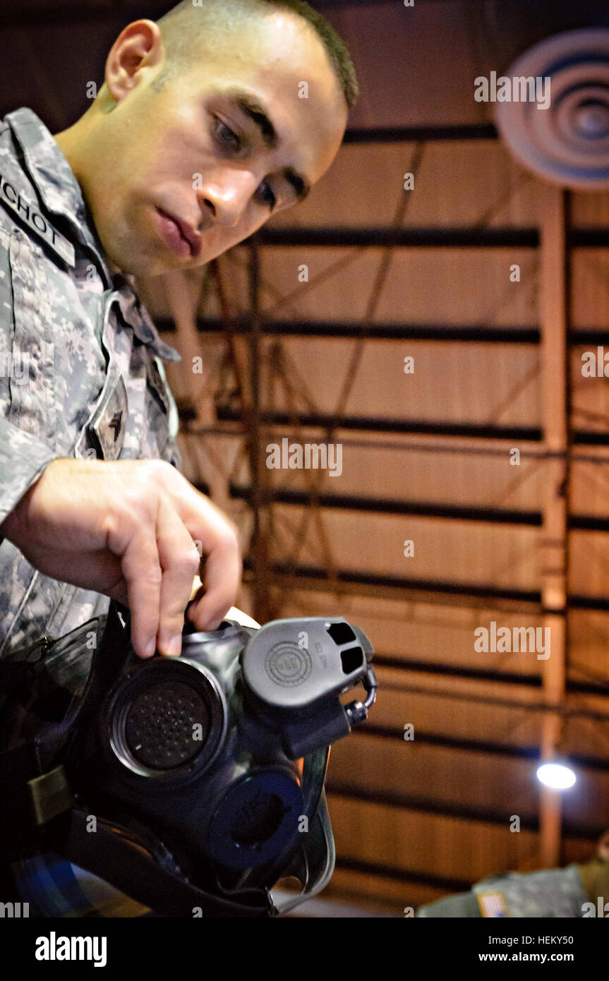 Sgt. Christopher Couchot inspects his Nuclear, Biological, Chemical ...