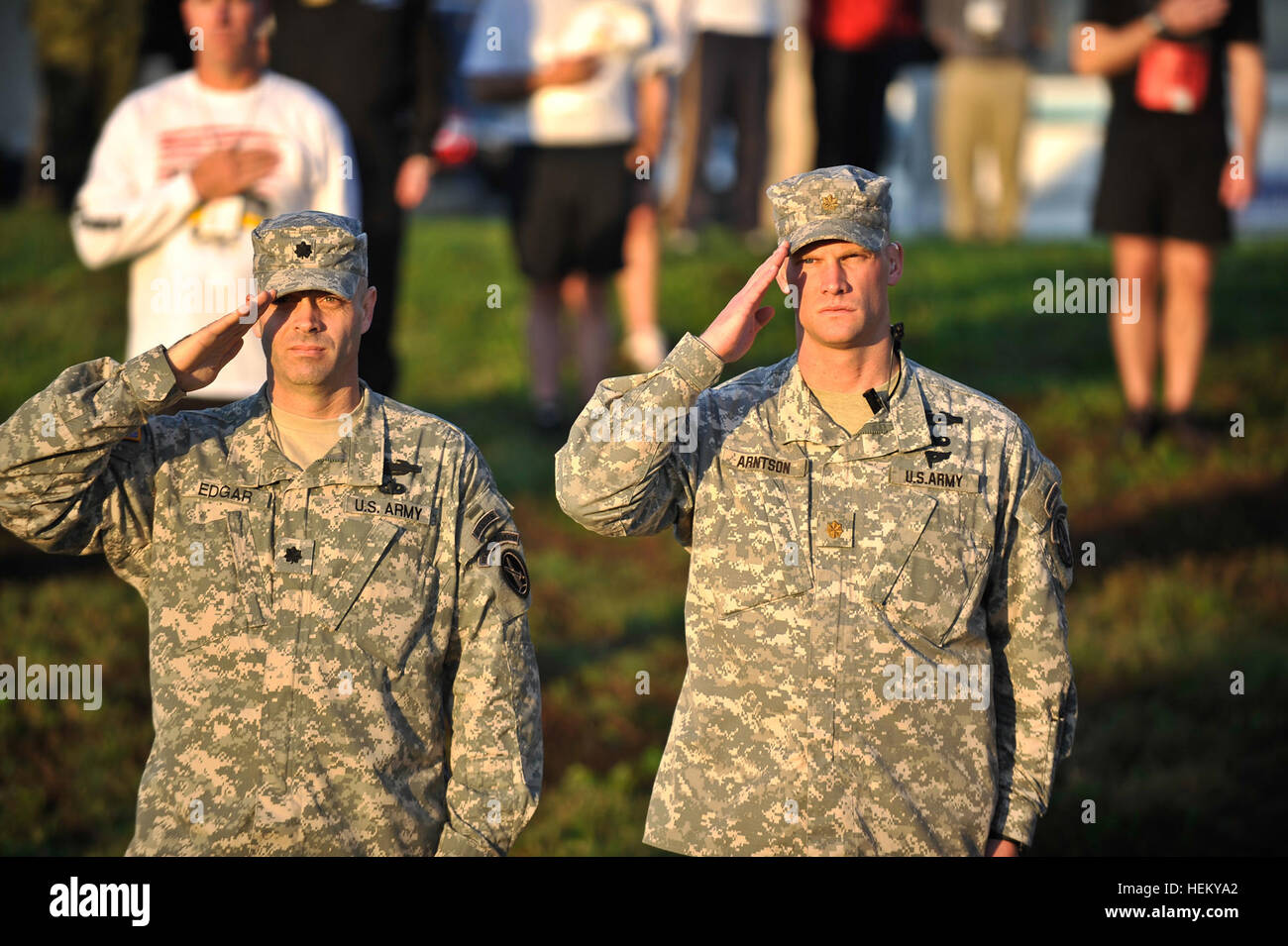 U.S. Army Lt. Col. Edgar and Maj. Arntson salute during the playing of ...