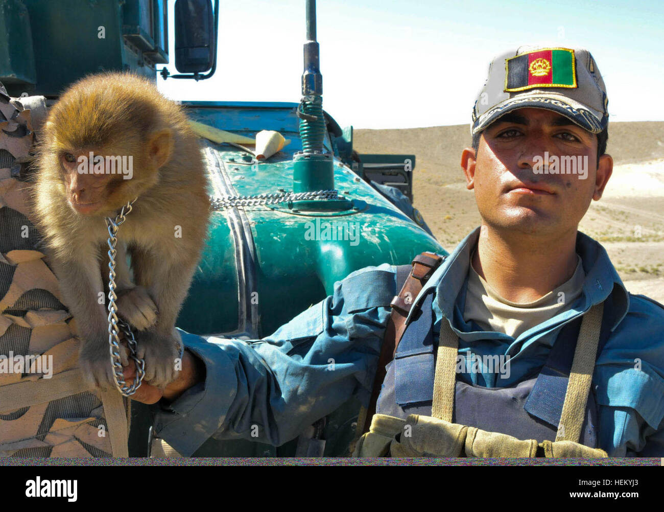 An Afghan Uniformed Police officer poses with his pet monkey while on ...