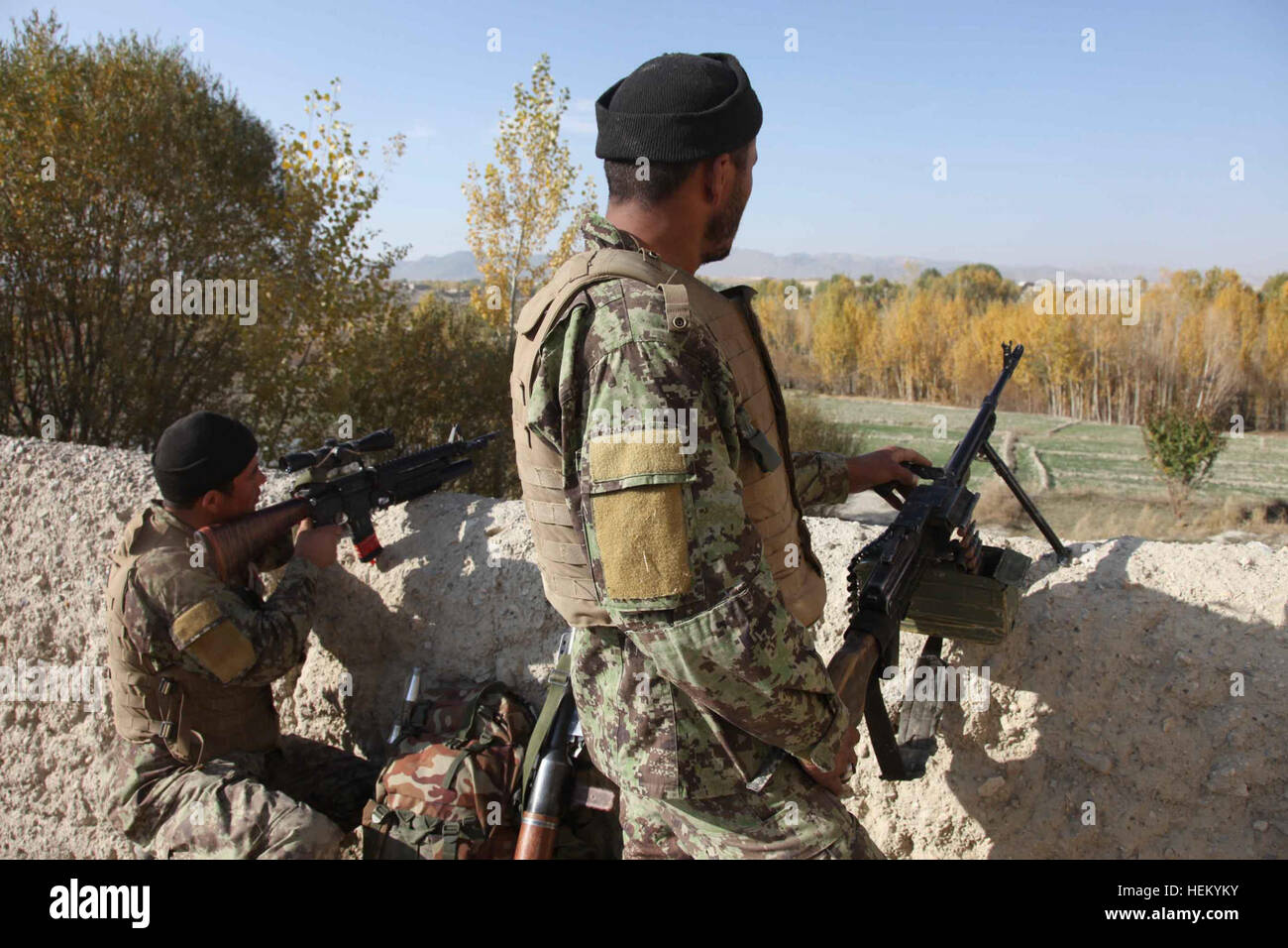 Afghan National Army Soldiers scan a tree line at the support by fire ...