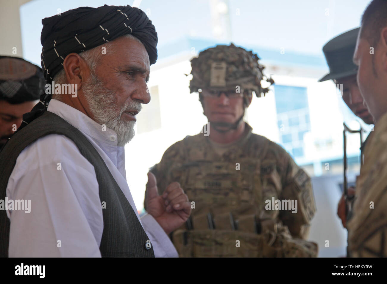 District Governor, Niaz Sarhardi, speaks with U.S. soldiers and local ...