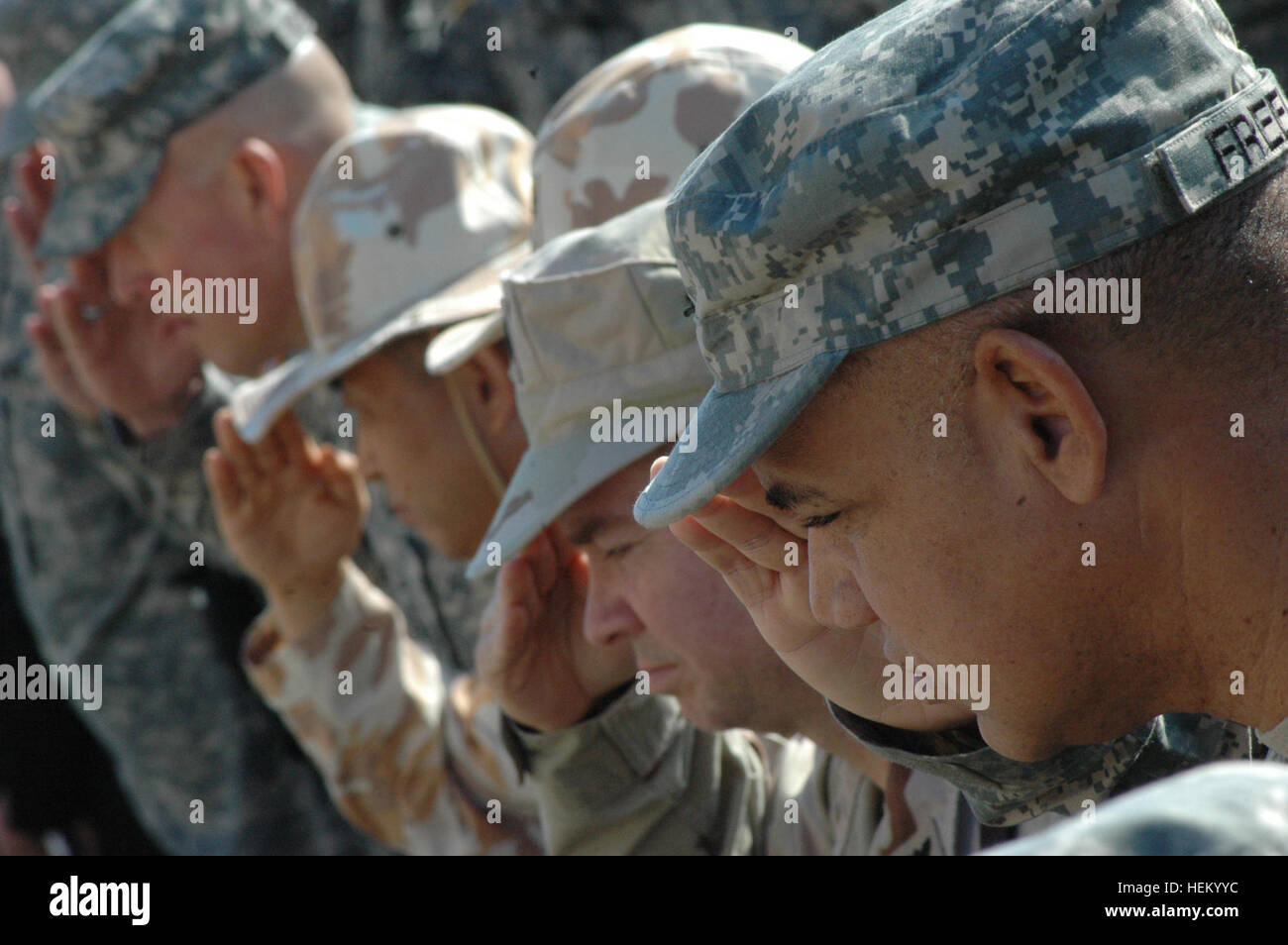 CAMP VICTORY, Iraq – Service members salute during a ceremony marking ...