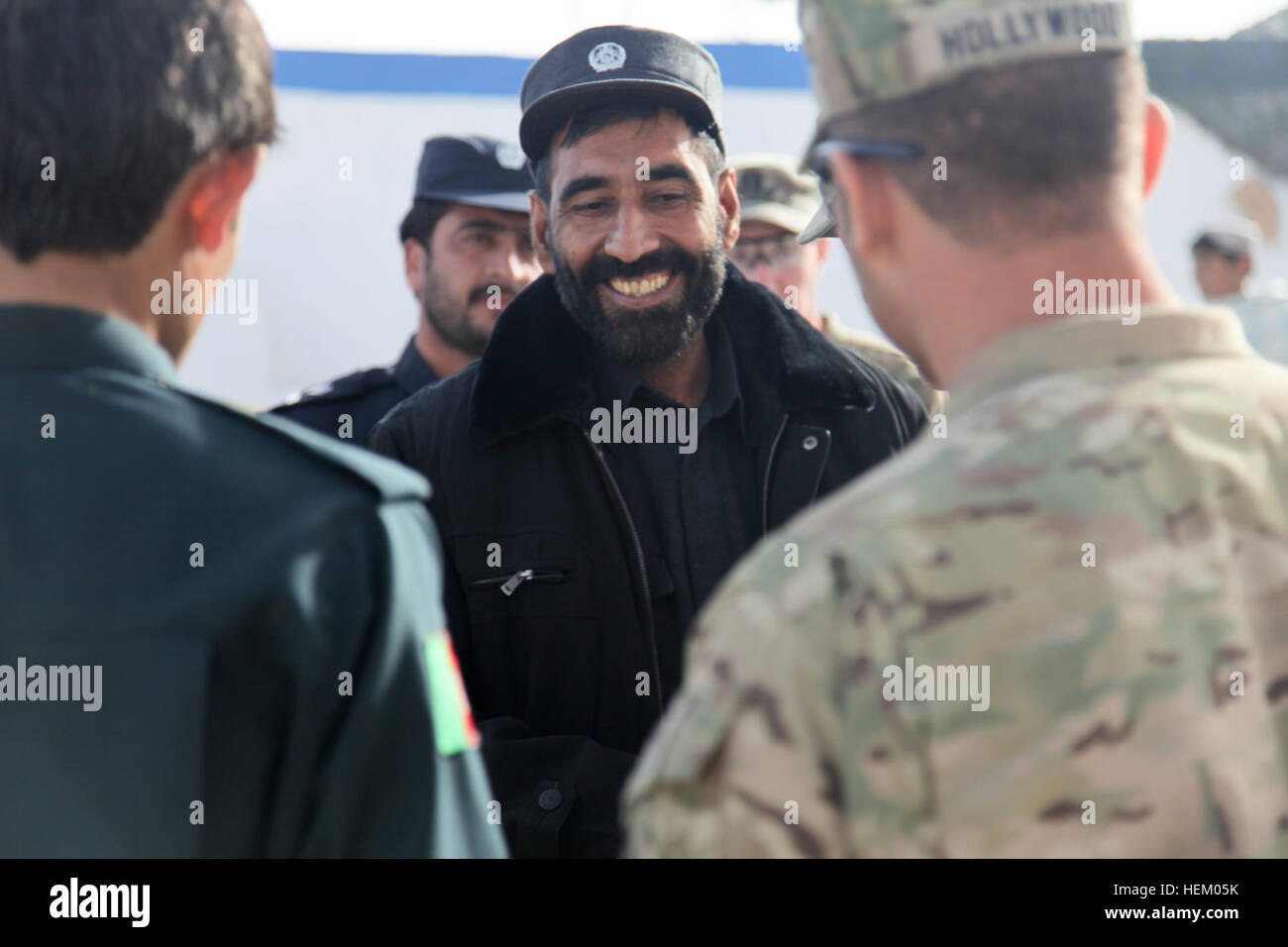 Masom Kahn, the Zhari district chief of police, talks with locals at ...