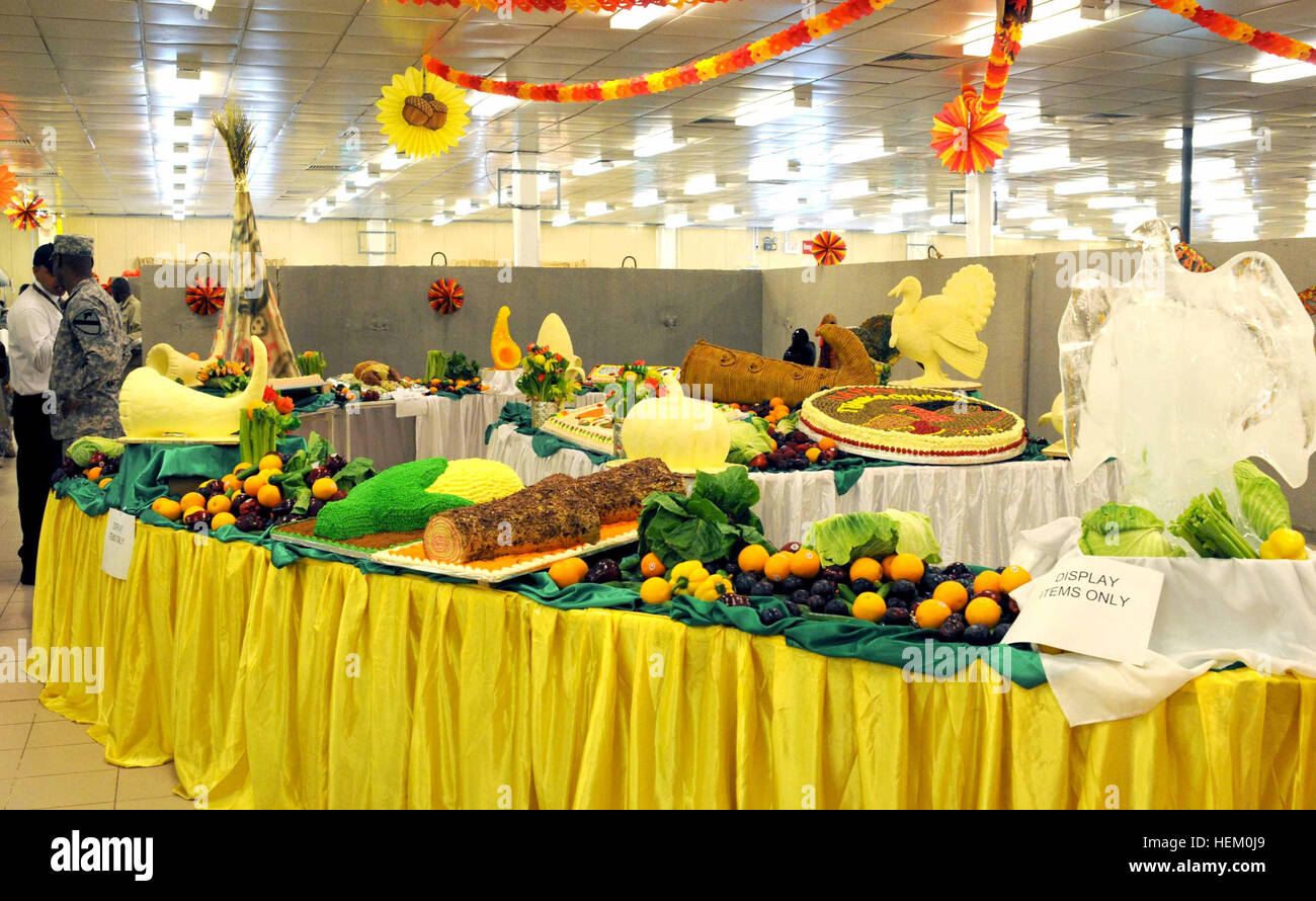 A Thanksgiving display of fresh fruit, cakes, tipis, food and ice ...