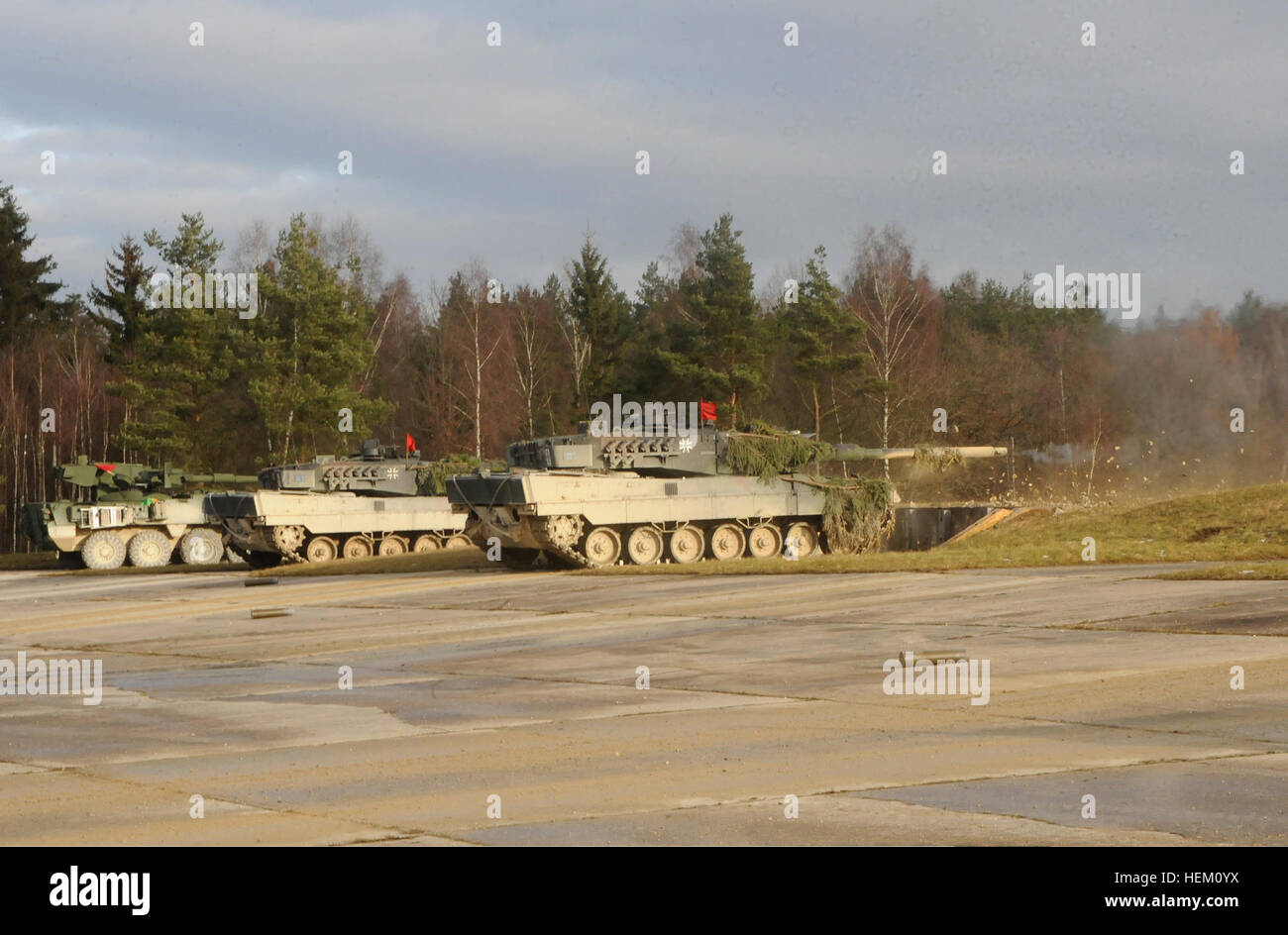 A German army Leopard 2 tank, accompanied by another Leopard 2 and a U ...