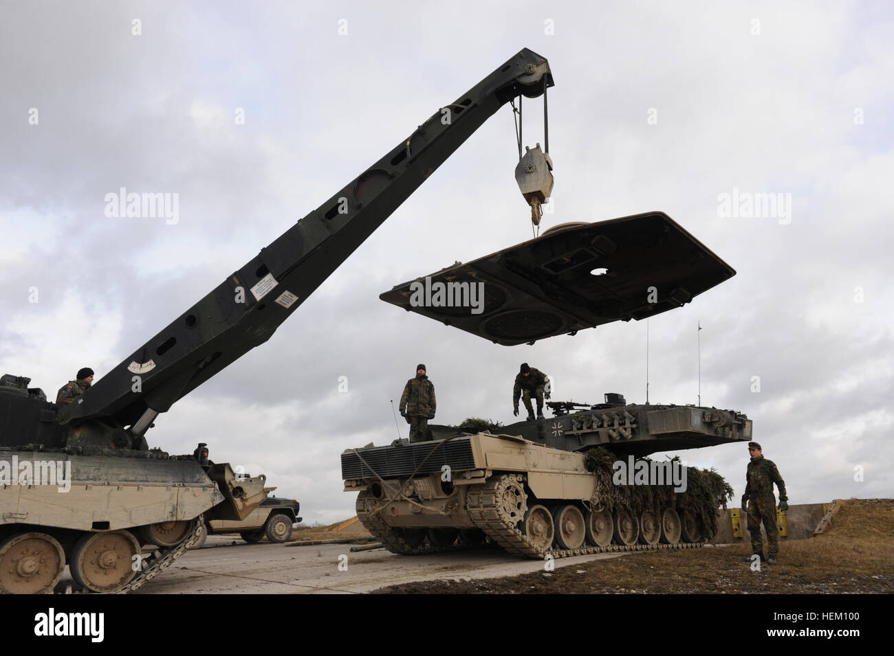 GRAFENWOEHR, Germany-- A German recovery vehicle lifts the engine panel ...