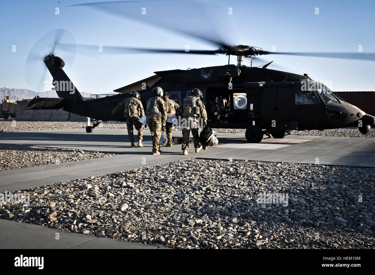 The flight crew on a medical evacuation helicopter loads a patient at ...