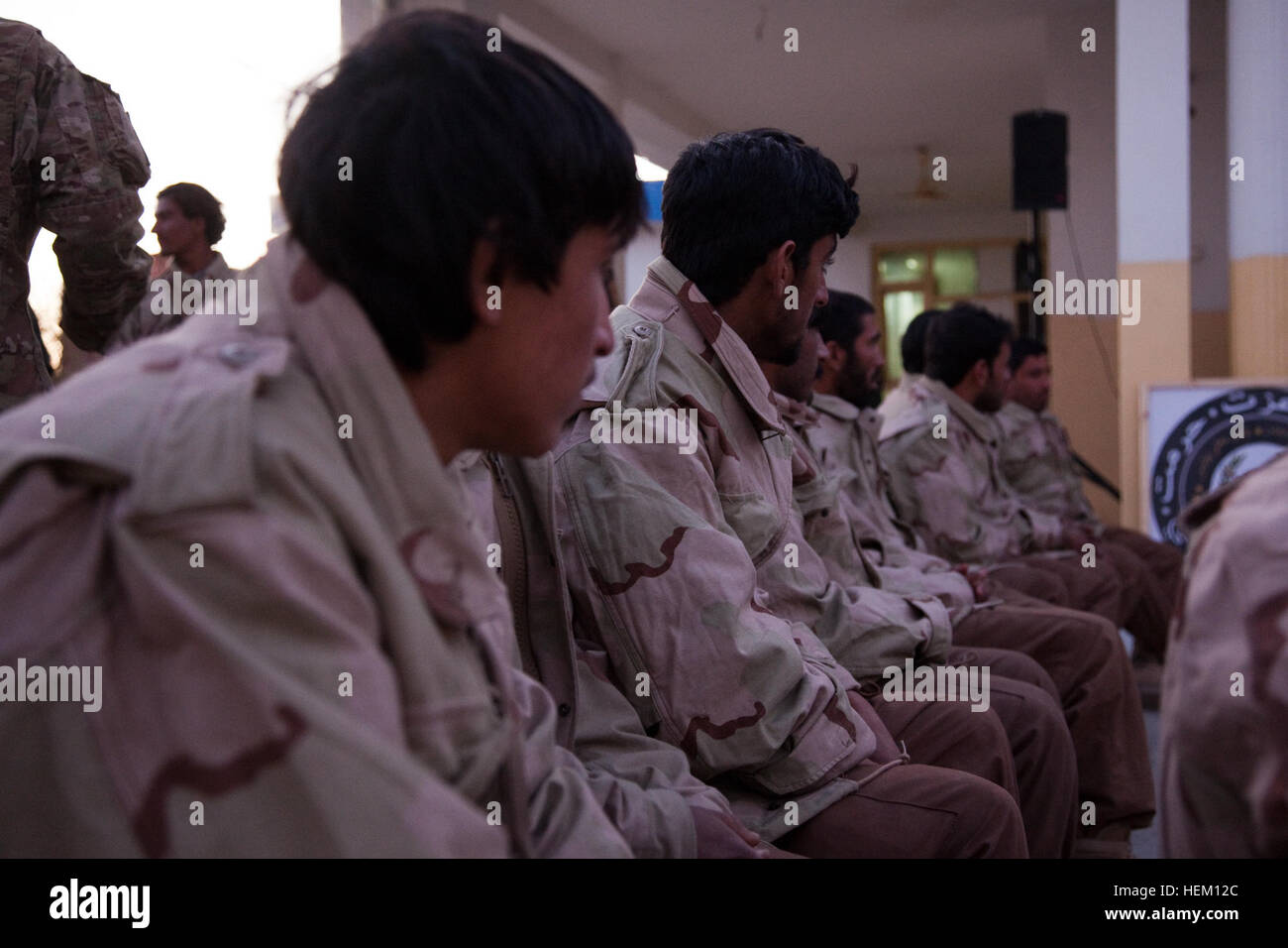 Local men sit at a graduation ceremony to become verified as ...