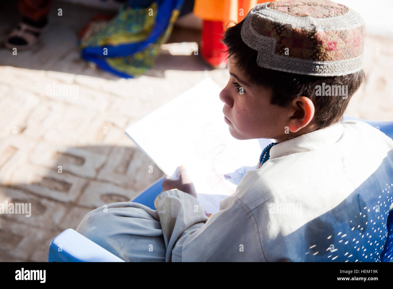 An Afghan boy draws in a coloring book at the women's center outside of ...