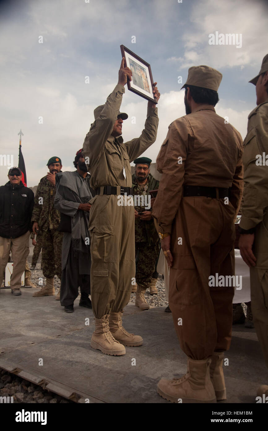 A local man holds up his certificate at Combat Outpost Senjaray ...