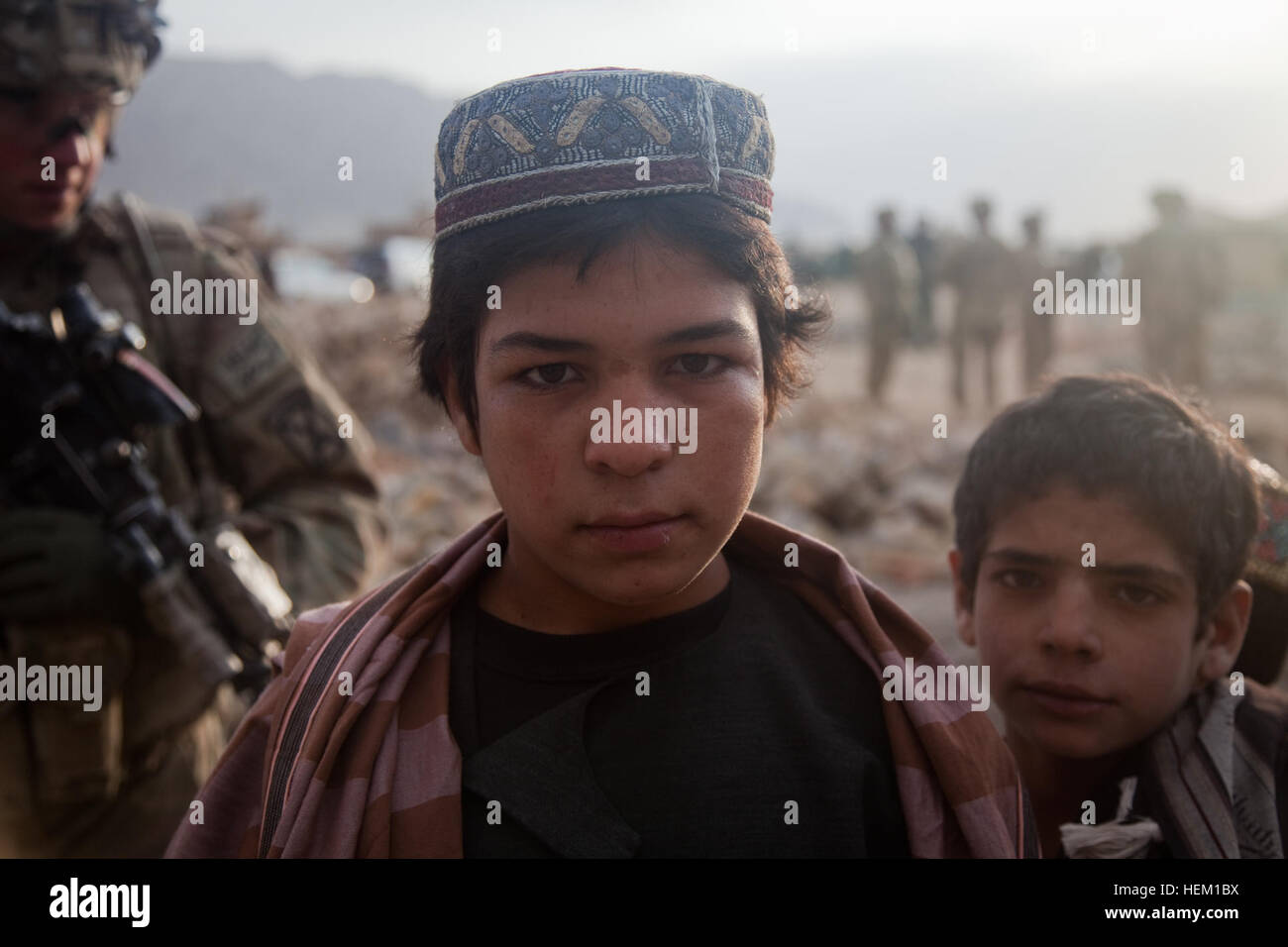 Local boys look at the camera outside of Combat Outpost Senjaray, Kandahar province, Afghanistan ...