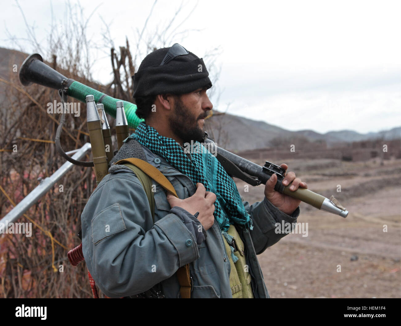 An Afghan Uniformed Police officer provides security with a rocket ...