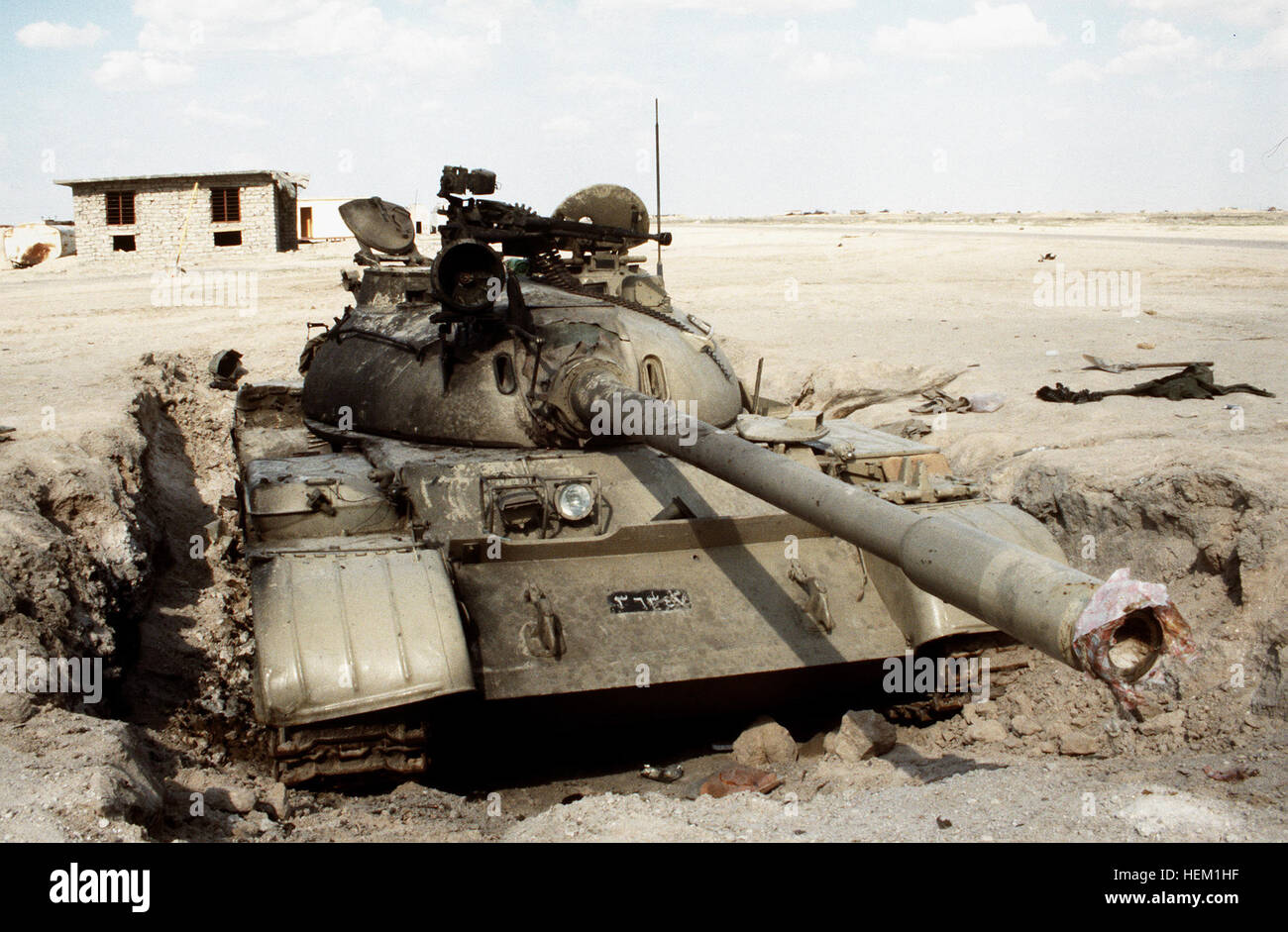 A destroyed Iraqi T-55 main battle tank stands in the sand at Jalibah ...
