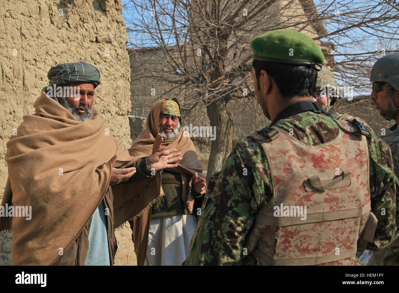 Local Afghan men speak with U.S. Army Staff Sgt. Jonathan Enlow, from ...