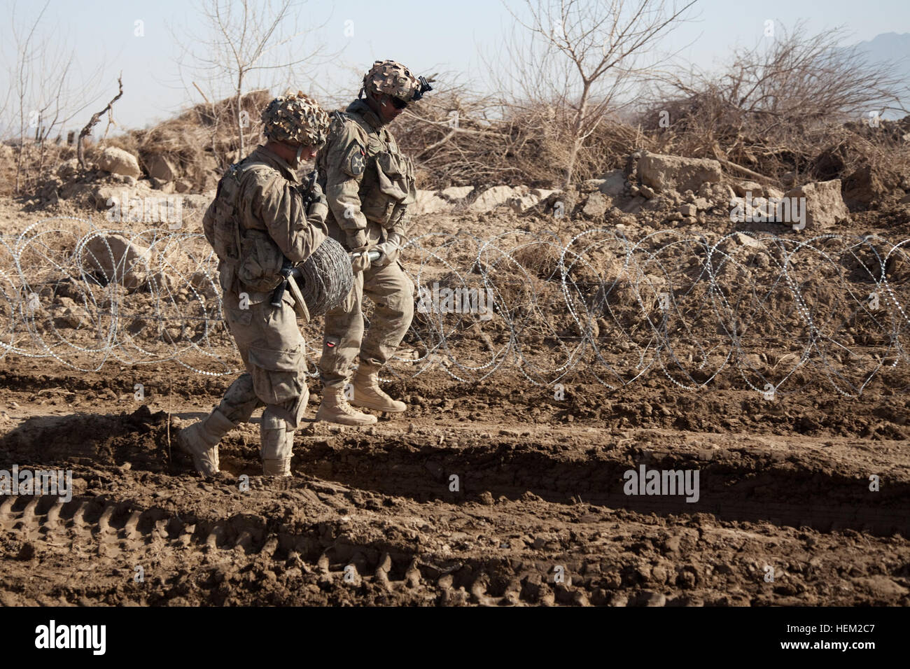 U.S. Army Soldiers with 5th Battalion, 20th Infantry Regiment unroll a ...