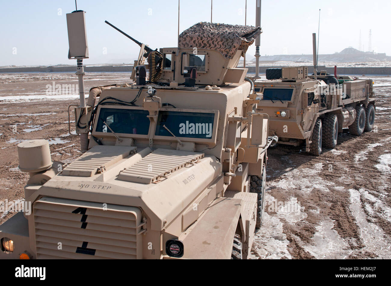 A mine resistant ambush protected truck (front) and an MRAP Heavy ...