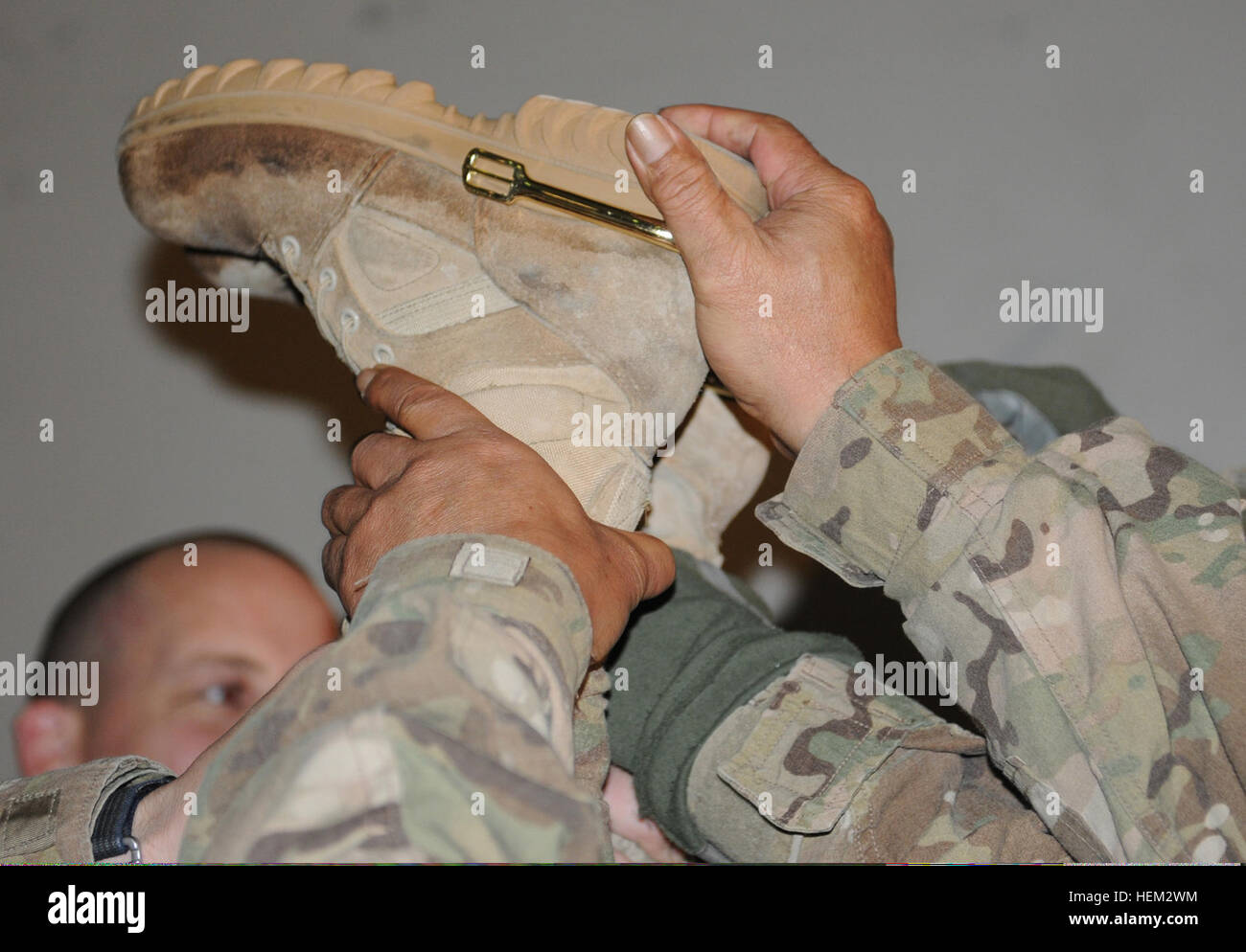 Candidates are held upside down as they are awarded golden combat spurs ...