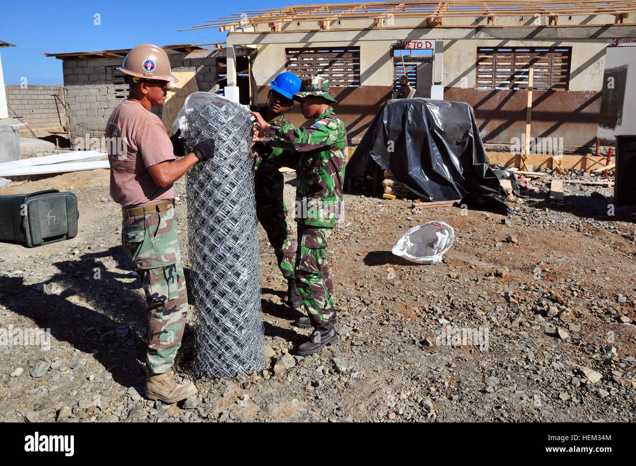 Builder 1st Class Antonio Escobar, left, assigned to Naval Mobile ...