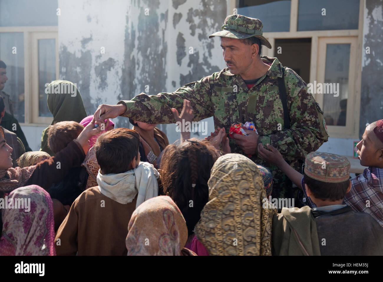 Afghan National Army 1st Sgt. Sai Paluka passes out candy to local ...