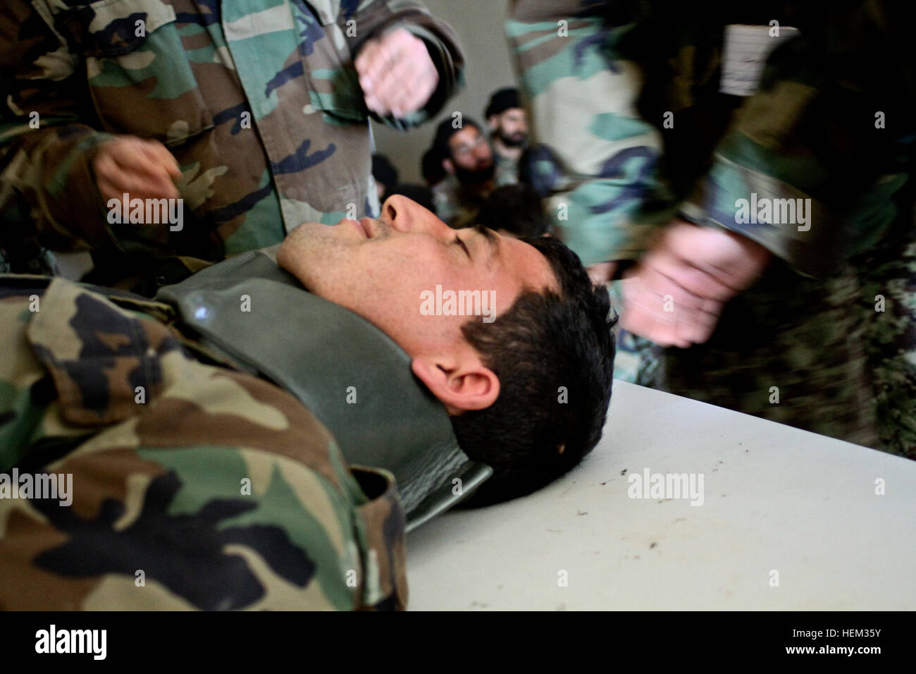 Afghan National Army medics check how a neck splint is applied during ...