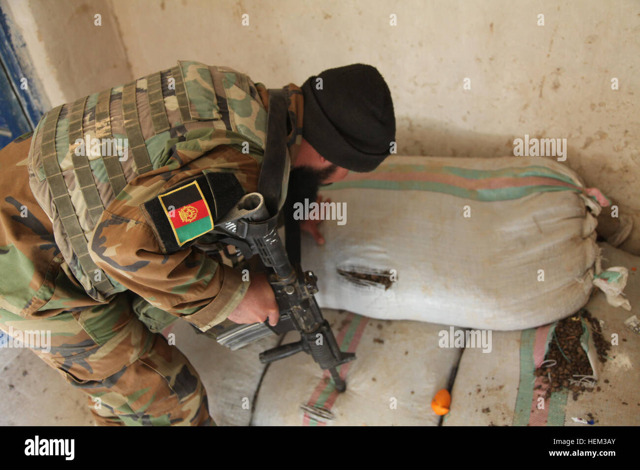 An Afghan National Army commando conducts a search of explosives and ...