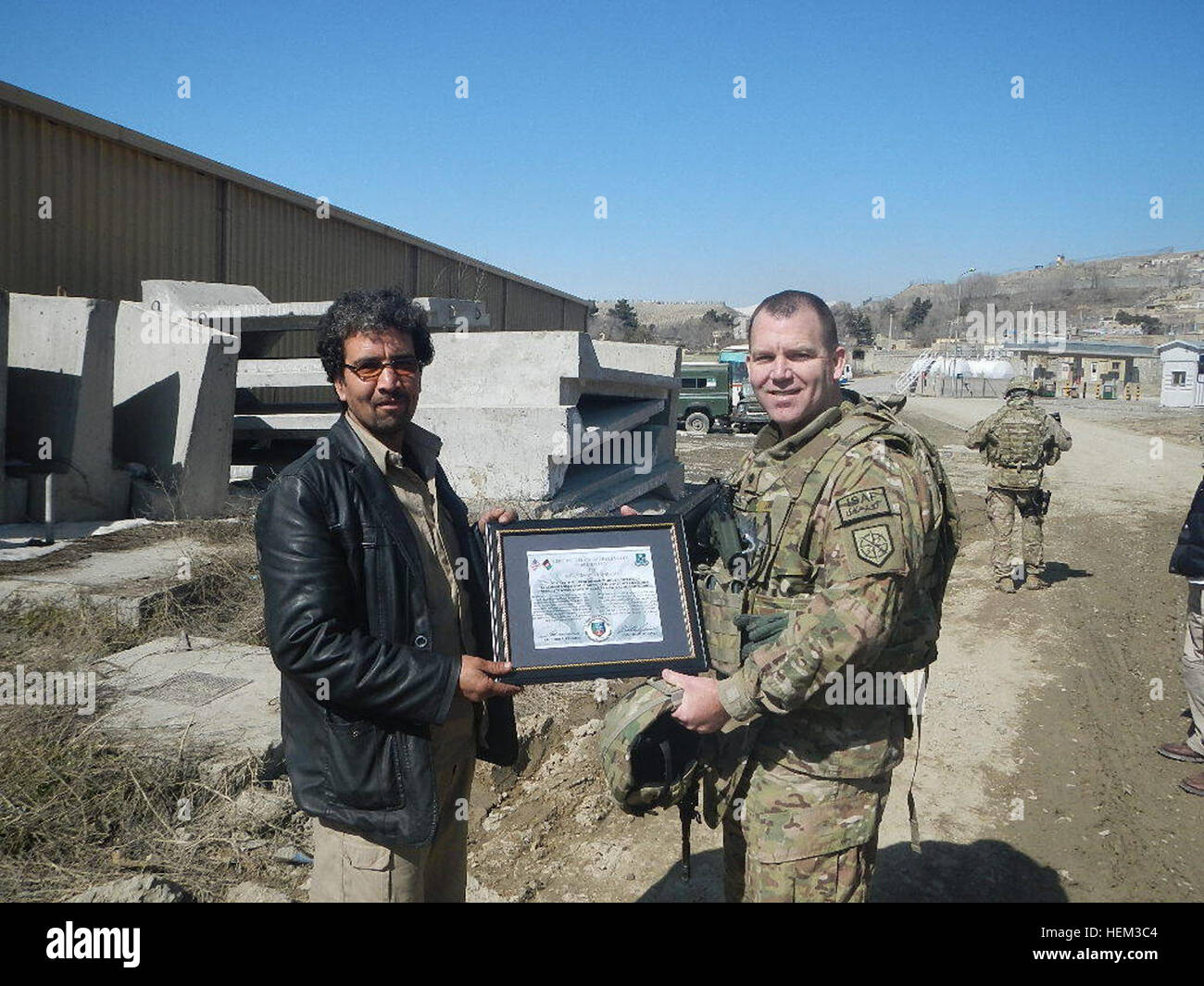 Lt. Col. Todd Perkins, the New Kabul Compound commander, presents a ...