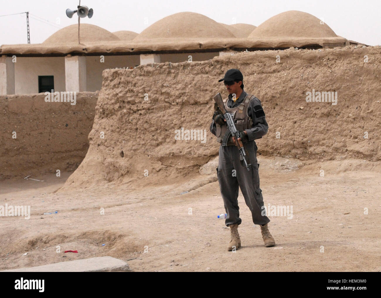An Afghan security guard provides security to an Afghan National ...