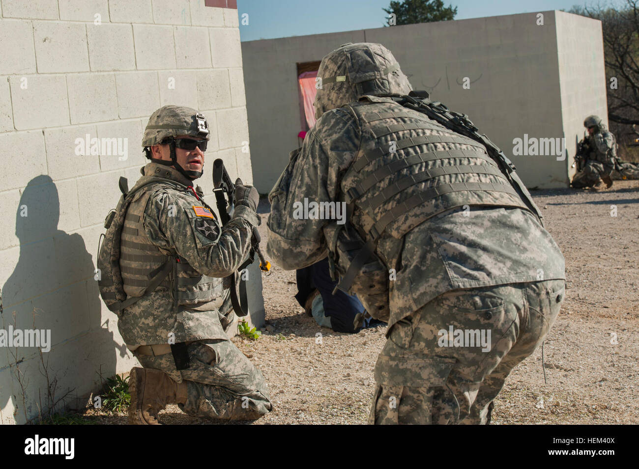 Spc. Scott Kraft and Staff Sgt. Patrick Hoglund, search an insurgent ...