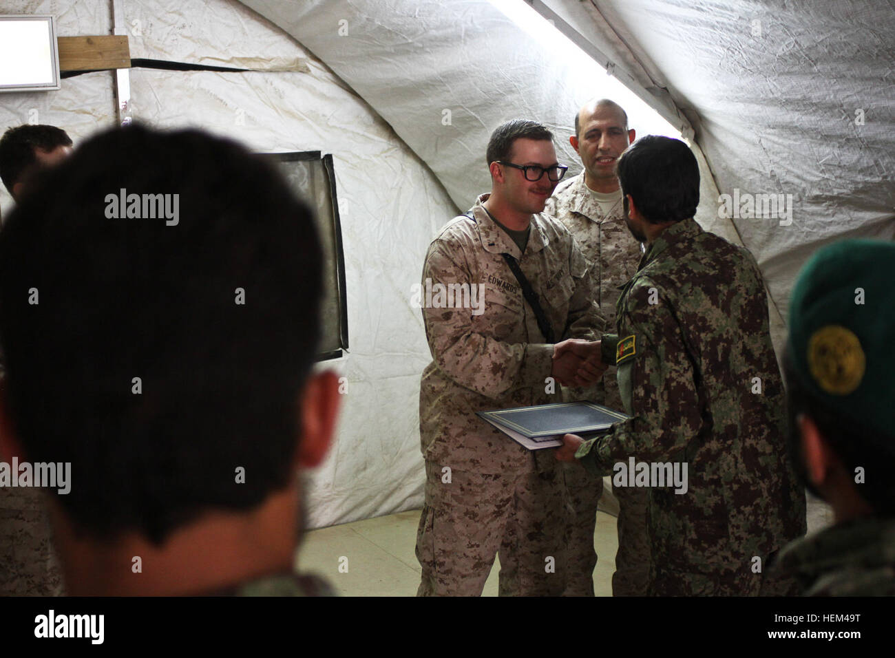 U.S. Navy Lt. Jg Jacob Edwards, with Task Force Leatherneck, shakes the ...