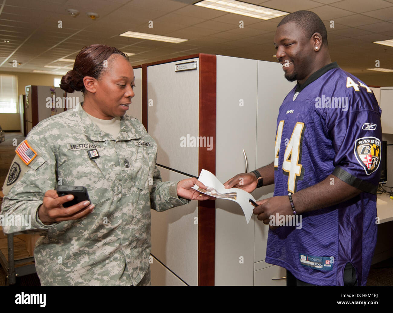 Master Sgt. Kimberly Mercado receives an autograph from Vonta Leach, a ...