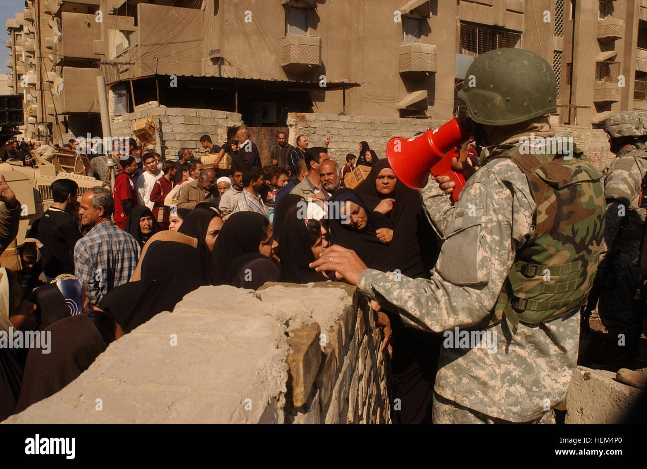 An Iraqi Interpreter contracted by the U.S. Army, uses a bullhorn to ...