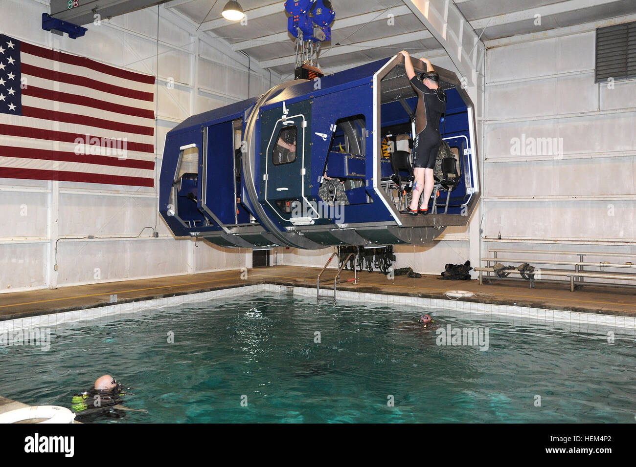 U.S. Army helicopter pilot trainees and instructors sit above water in ...