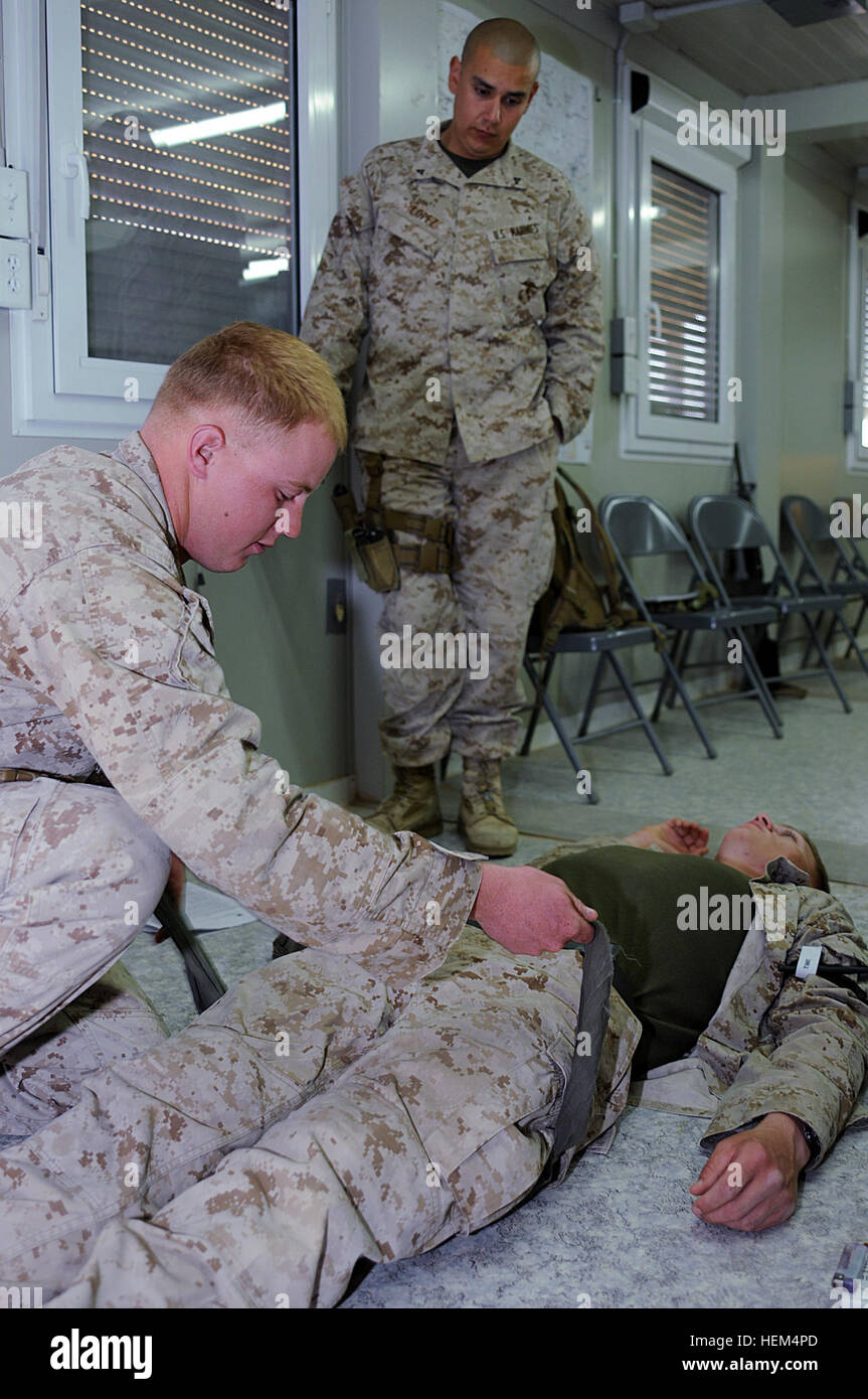 A military police trainee creates an improvised pelvic splint during a ...